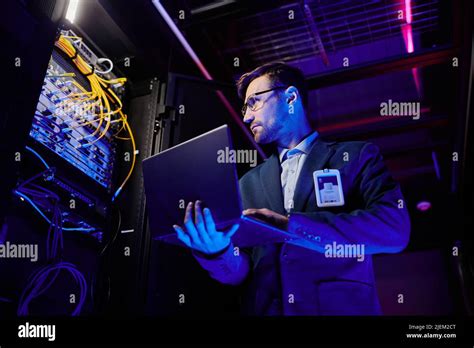 Low Angle Portrait Of Professional Network Engineer Setting Up Servers