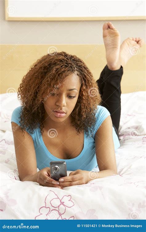 Teenage Girl In Bedroom With Mobile Phone Stock Image Image Of Home