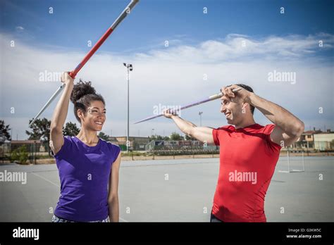 Man Instructing Female Javelin Thrower At Sports Ground Stock Photo Alamy