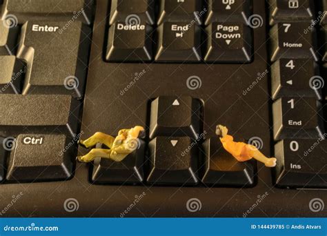 Miniature Man And Woman Sitting On Computer Keyboard Family Conflict Divorce Concept Stock