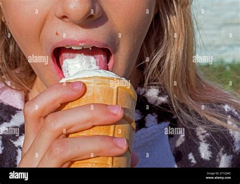 Girl Licks Pistachio Ice Cream In A Waffle Cup With Her Tongue On A
