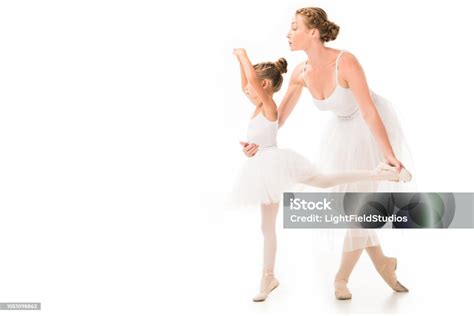투투 돕는 작은 발레리 나 운동에 고립 된 흰색 배경에서에서 성인 여성 트레이너의 측면 보기 강사에 대한 스톡 사진 및 기타