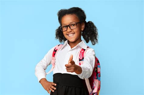 Premium Photo Happy African American Schoolgirl Pointing Finger At