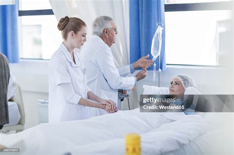 Doctor And Nurse At Very Sick Patients Bed In Hospital High Res Stock