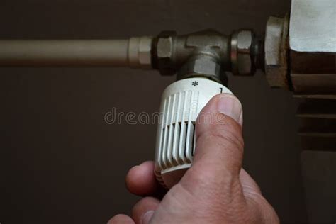 Man Adjusting Thermostatic Radiator Valve Controlling Central Heating Temperature Stock Image
