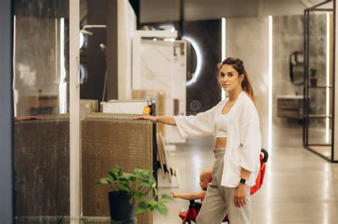 A Young Mother Chooses A Tile In A Store Stock Image Image Of Style