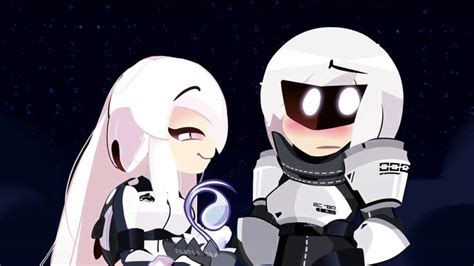 Two People Dressed In Futuristic Garb Standing Next To Each Other With Their Arms Around One Another