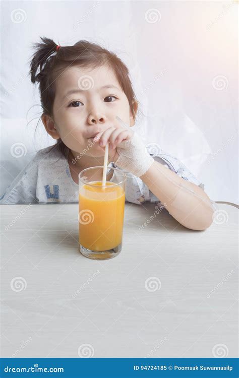 Asian Girl While Sucking Orange Juice To Nourish The Body Stock Image