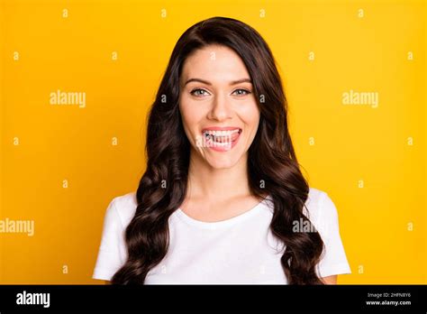 Portrait Of Attractive Cheerful Wavy Haired Girl Licking Lip Enjoying