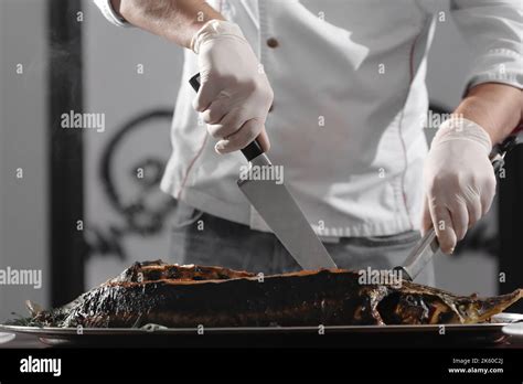 Cooked Fish In A Professional Kitchen Chef Cuts Sturgeon Fish Stock