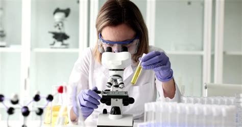 Lady Scientist Examines Sample Under Microscope Holding Flask Stock Footage Video Of Scientist
