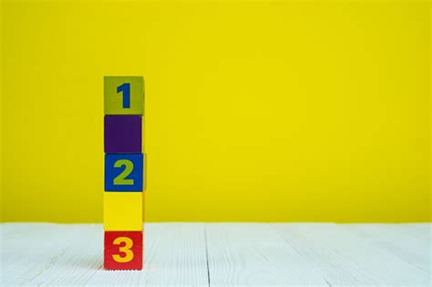 Square Block Puzzle Number 1 2 And 3 On Table With Yellow Background