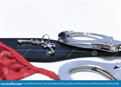 Sex Toys Leather Paddle And Handcuffs With Keys And Women S Red Panties On A White Background