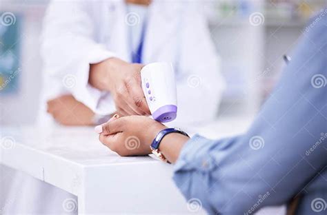 Thermometer Temperature Check And Hands Of People At A Pharmacy For