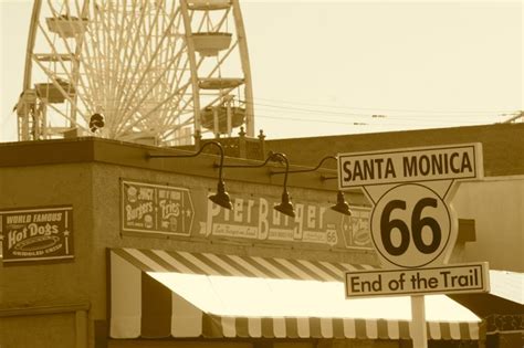 An Old Photo Of Santa Monica And The Sign For The Route 66 In Front Of