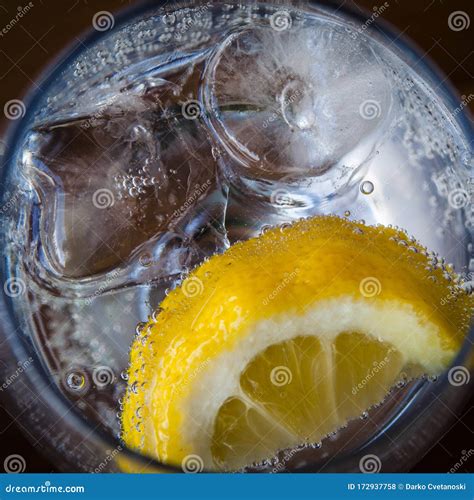 Cold Refreshing Drink In A Glass With Sparkling Water Ice And Lemon