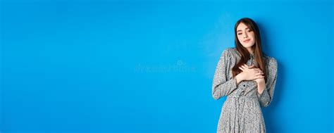 Romantic Beautiful Woman In Dress Holding Hands On Heart Smiling