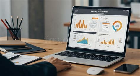 Analyzing Startup Data On Laptop With Charts At Modern Workspace Stock