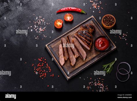 Cooked Grilled Chuck Eye Roll Steak On A Chopping Board Dark