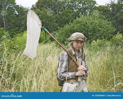 A Young Woman Entomologist Dressed In Country Style With An Insect Net