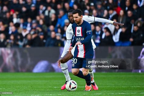 Karl Toko Ekambi Of Stade Rennais And Lionel Messi Of Psg During The