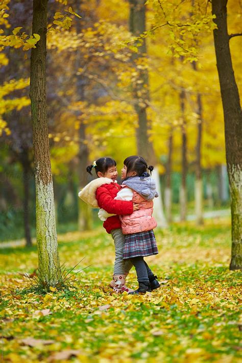 Two Lovely Asian Girl Having Fun In The Autumn Woods By Stocksy
