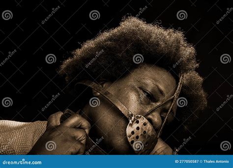 Face Portrait Of A Black Woman Imprisoned With An Iron Mask On Her Face
