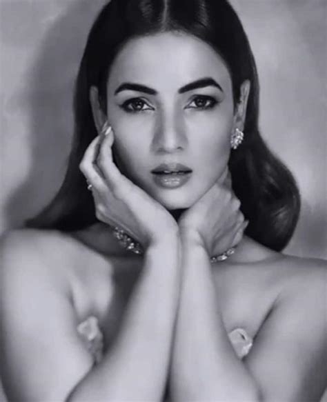 Sonal Chauhan Sizzles In Hot Silver Thigh High Slit Bodycon Gown With