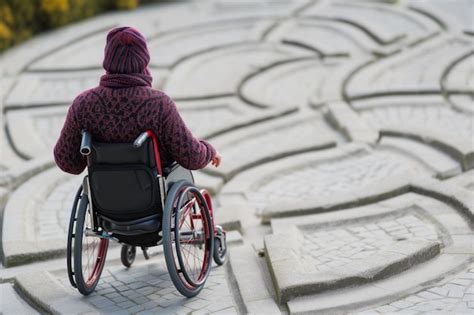 Premium Photo Wheelchair User Navigating Through A Paved Maze