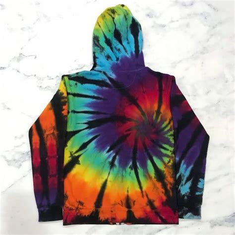 A Colorful Tie Dyed Hoodie Sitting On Top Of A White Marble Countertop