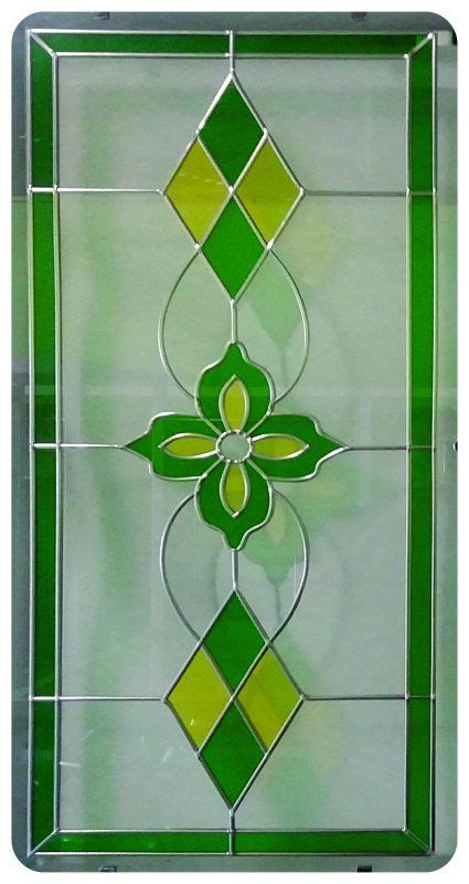 Green And White Stained Glass Window With Ornate Design
