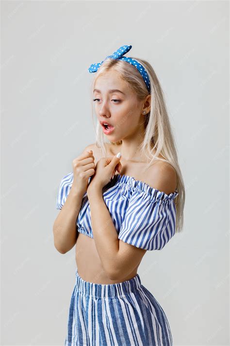 Premium Photo Playful Beautiful Blonde Girl In Summer Outfit Isolated