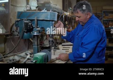 Employee Drills The Item In The Workshop With The Help Of A Drilling