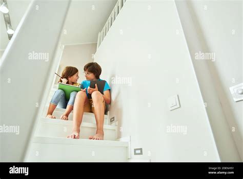 Homeschooling Concept Small Brother And Sister Sitting On Stairs At