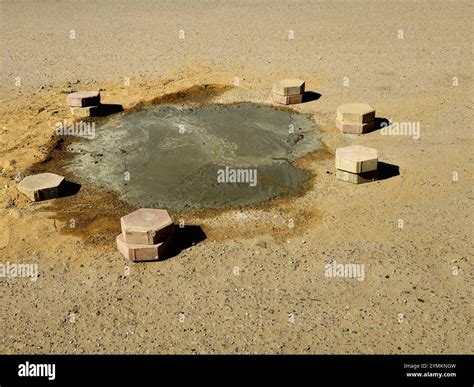 Maintenance Of A Small Area In The Asphalt With Some Cement Fixing A Small Hold On The Street