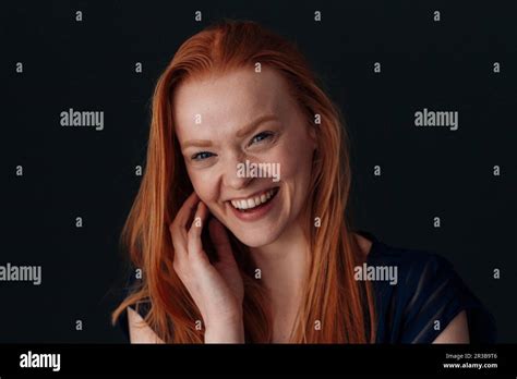 Happy Redhead Woman Against Black Background Stock Photo Alamy