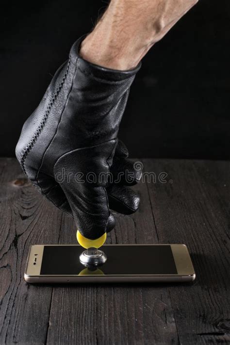The Hand Of An Attacker In A Black Glove Opens The Lock On A Smartphone