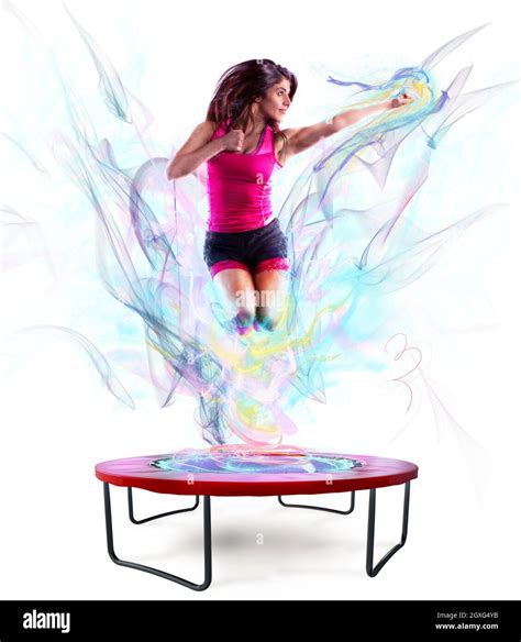 Fitness Teacher Jumps Nimbly On The Trampoline With Colour Light Effect