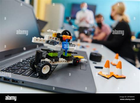 A Group Of Colleagues Working Together In A Robotics Laboratory Focusing On The Intricate