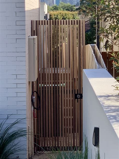 An Open Wooden Gate On The Side Of A Building