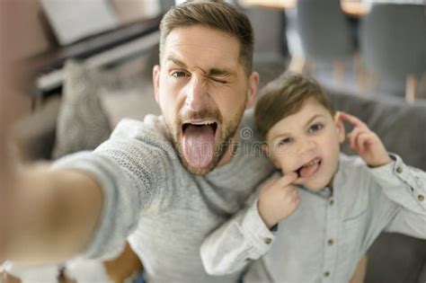 Happy Father And Little Son Having Fun Together In Living Room Play Air