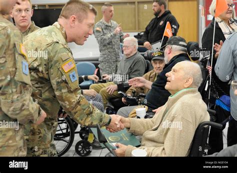 Officer Candidate Jonathan Ohearn Shakes The Hand Of Navy Chief Warrant Officer Ret Dale