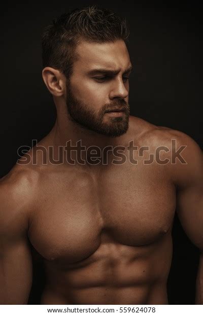 Fitness Model Konstantin Kamynin Portrait On Black Background