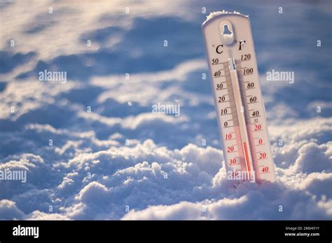 Thermometer In The Snow Extreme Cold Temperature At Winter Stock Photo