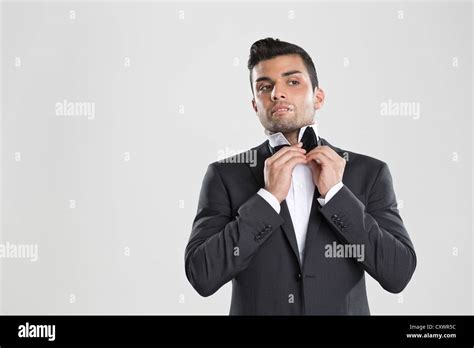 Man In Tuxedo Adjusting His Bow Tie Stock Photo Alamy