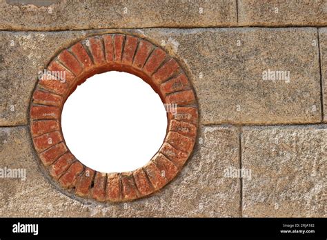 Close Up Of A Small Round Window With Brick Frame Isolated On White Background With Copy Space