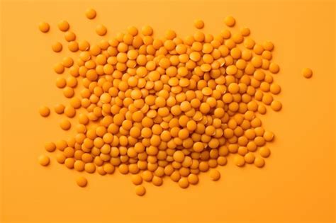 Premium Ai Image Ren Lentils On Orange Background Ai Generated
