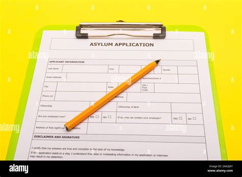 Asylum Concept Showing An Application Form For Asylum On A Yellow
