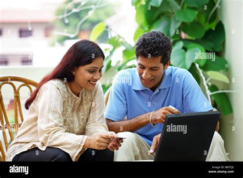 A Couple Using Laptop Stock Photo Alamy