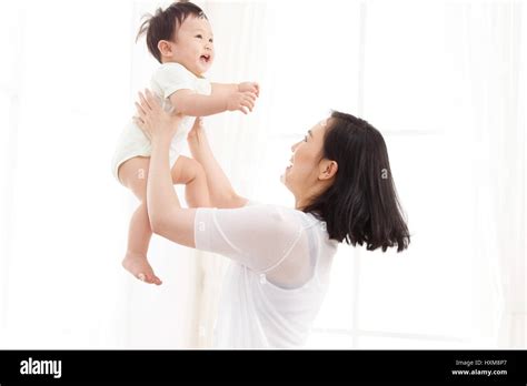 Mother Lifting Her Baby Stock Photo Alamy
